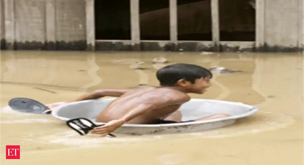 Children play in flood waters - | The Economic Times