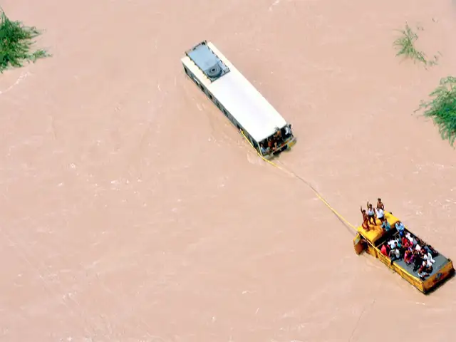 People wading in flood waters - Flood-like situation in western India ...