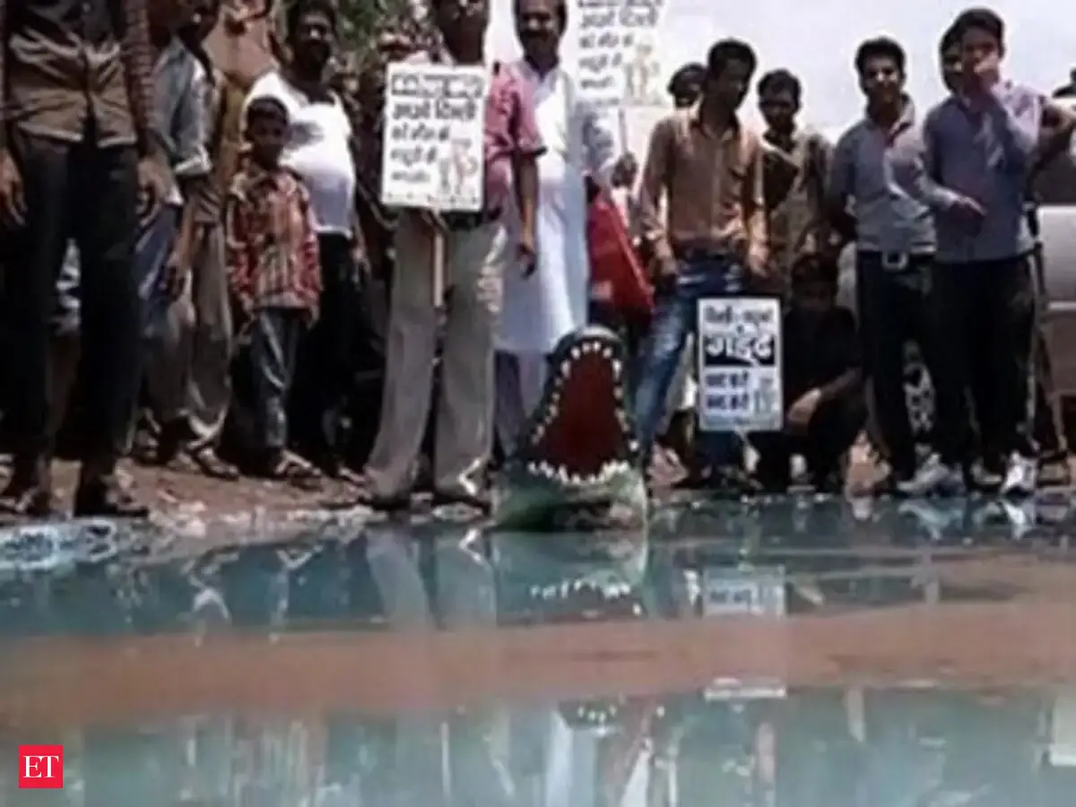 Congress places 'crocodile' inside potholes to symbolise dangerous ...