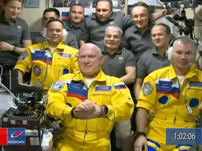 Russian cosmonauts sport colours of Ukrainian flag on their arrival at ...